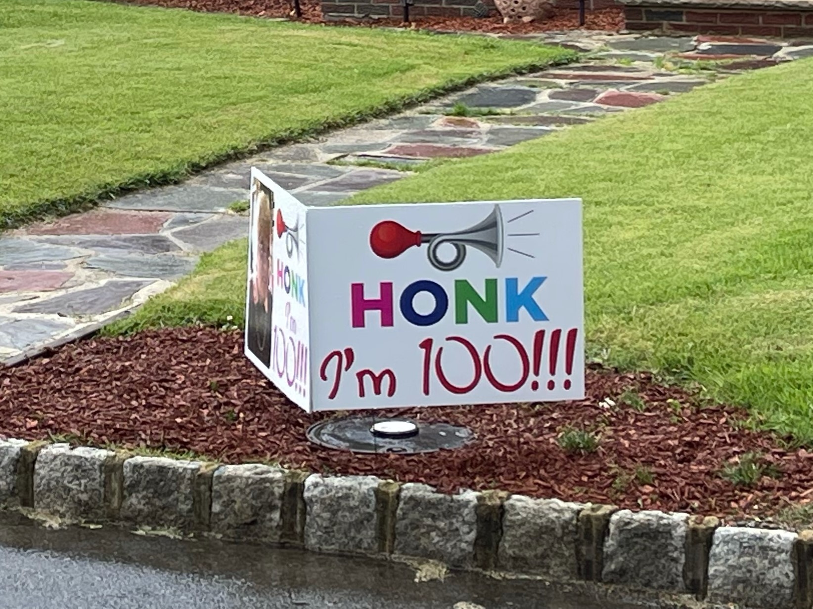 ART 52 PIX 1 Edythe 100th honk sign | Renna Media